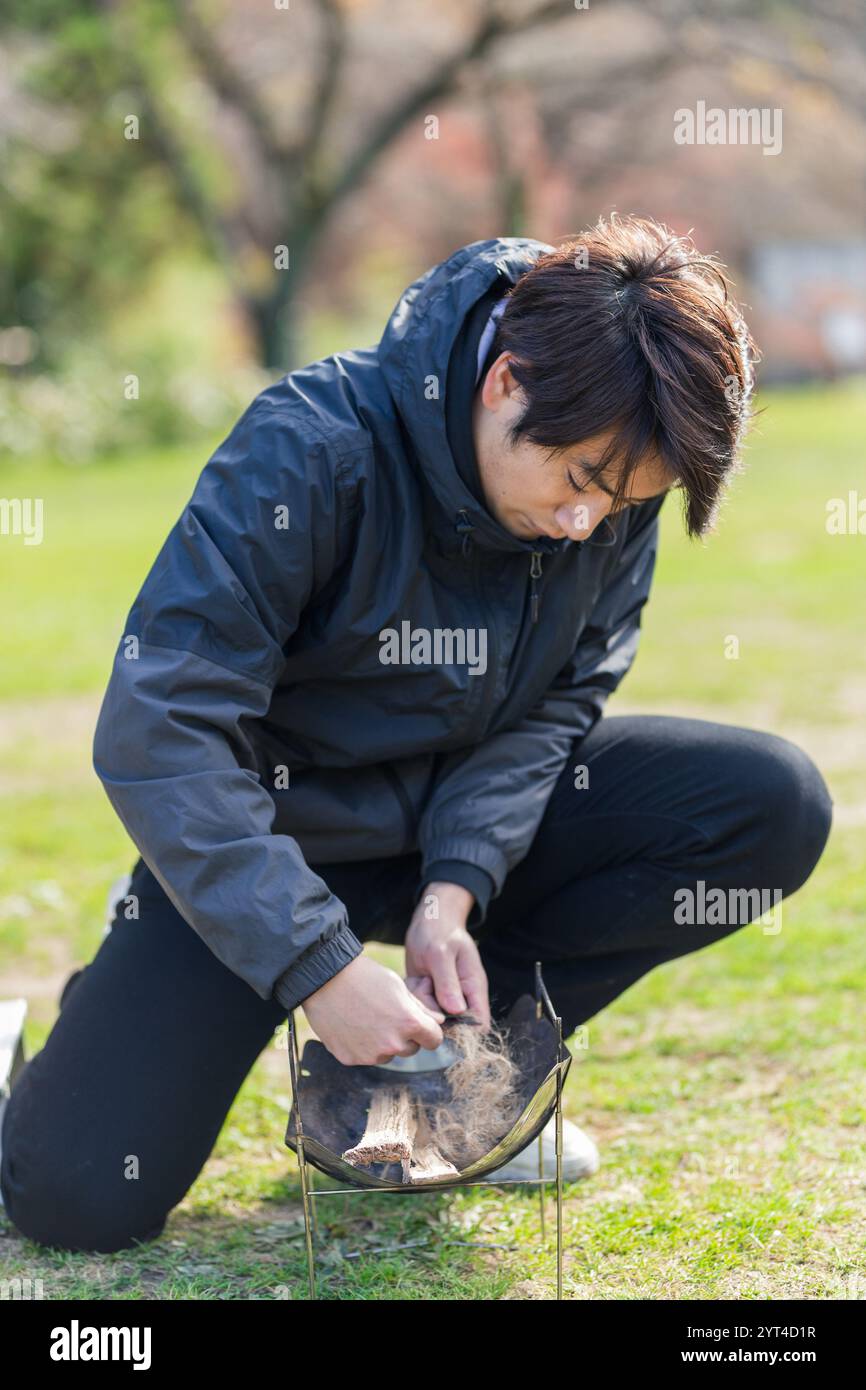 Man making a fire Stock Photo - Alamy