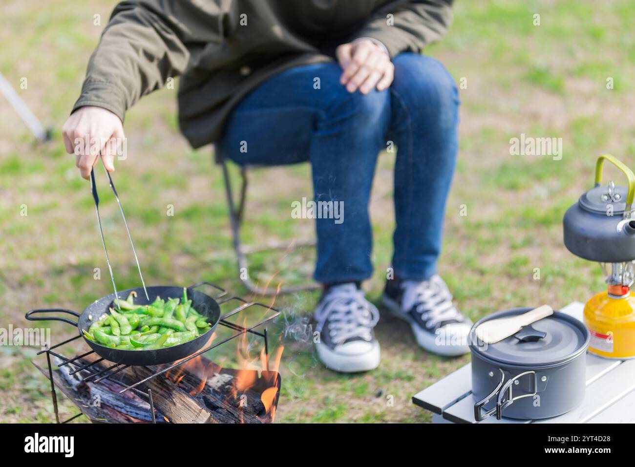 Woman frying edamame Stock Photo - Alamy