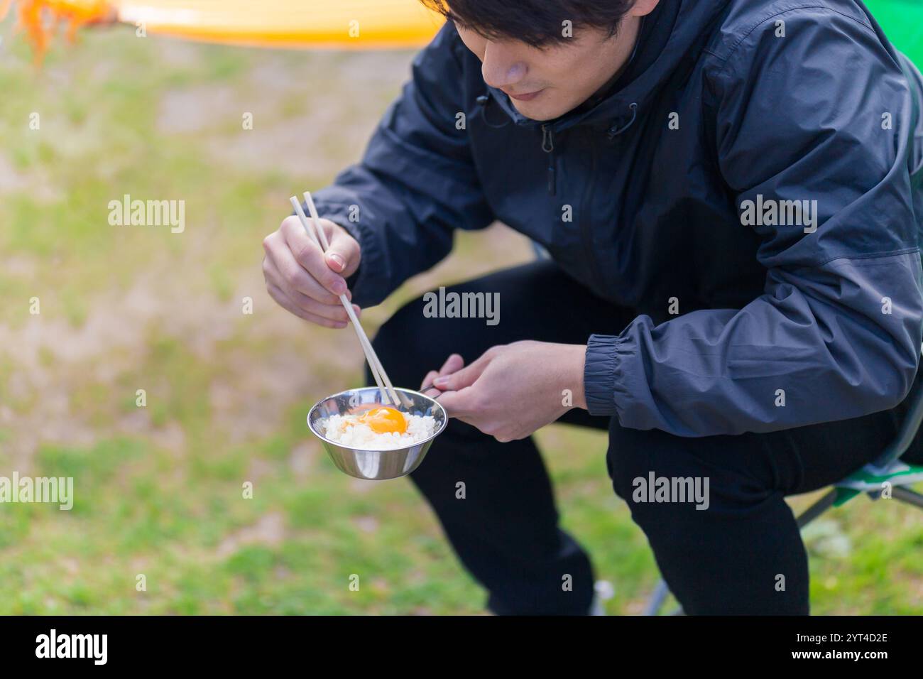 Man eating rice with egg Stock Photo - Alamy