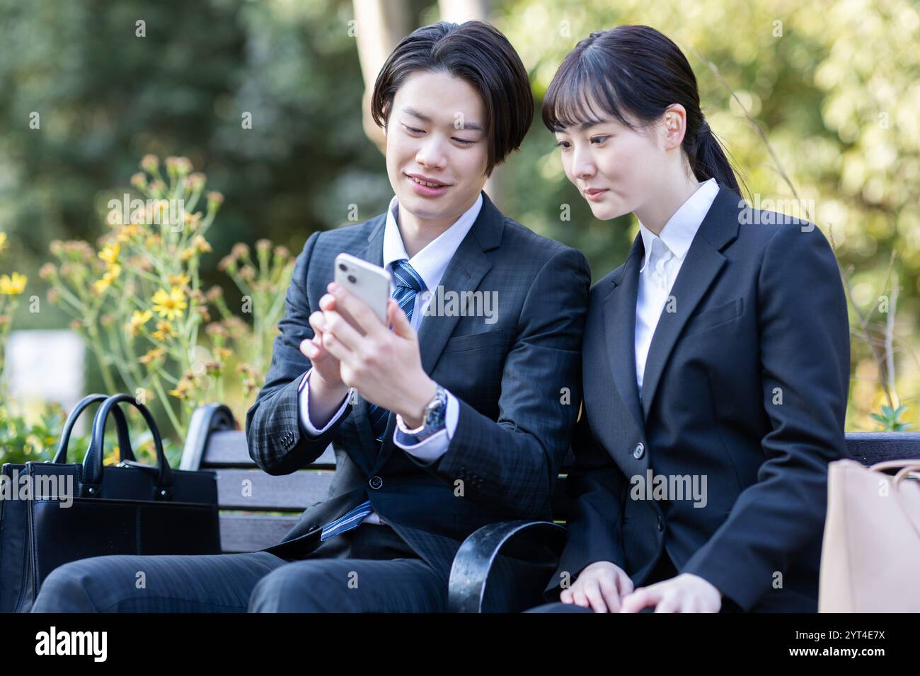 Businessman taking a break sitting on a bench Stock Photo - Alamy