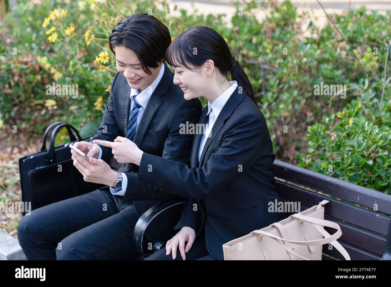 Businessman businesswoman sit on bench hi-res stock photography and ...