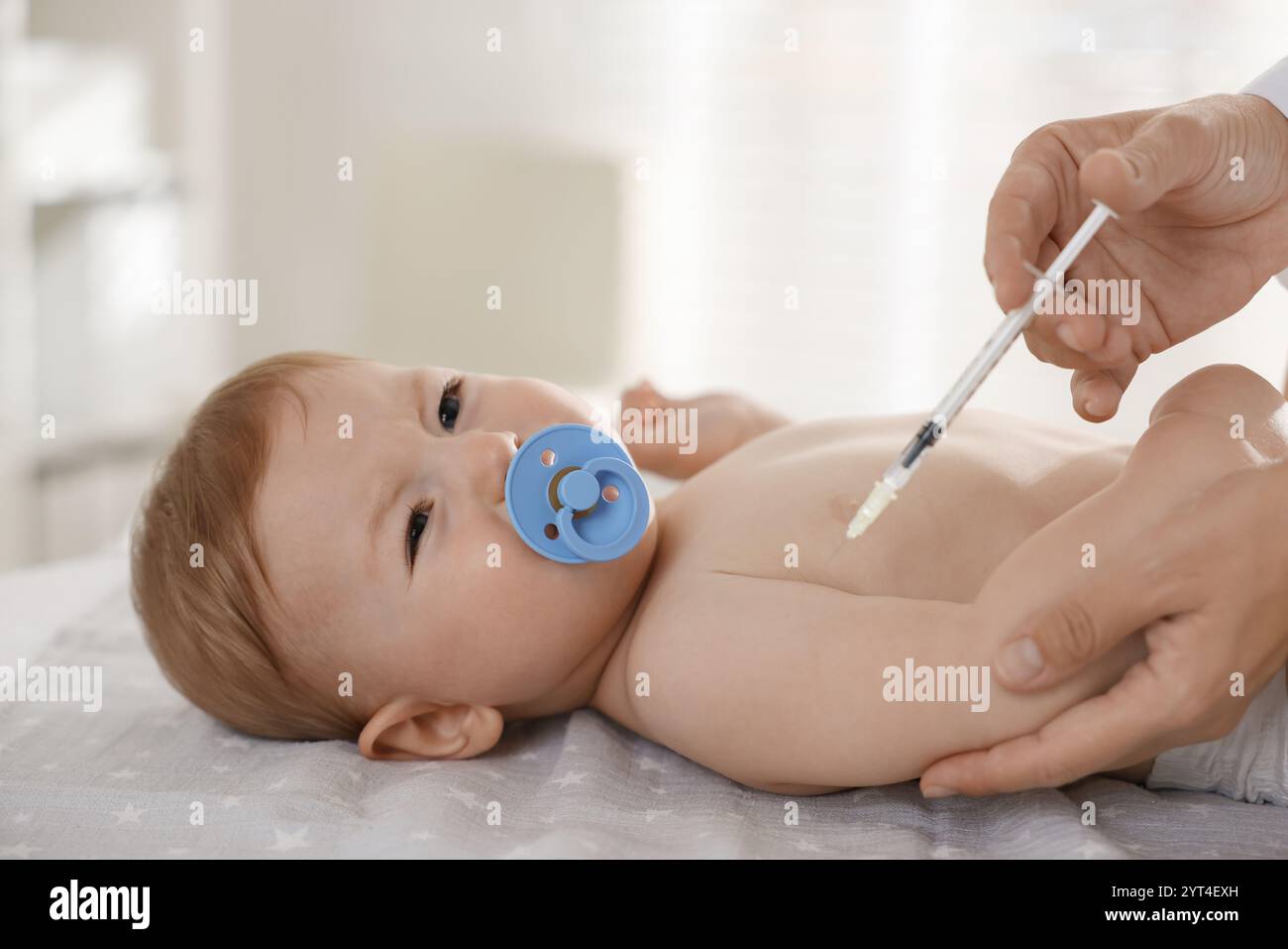 Pediatrician giving injection to cute baby in clinic, closeup Stock ...
