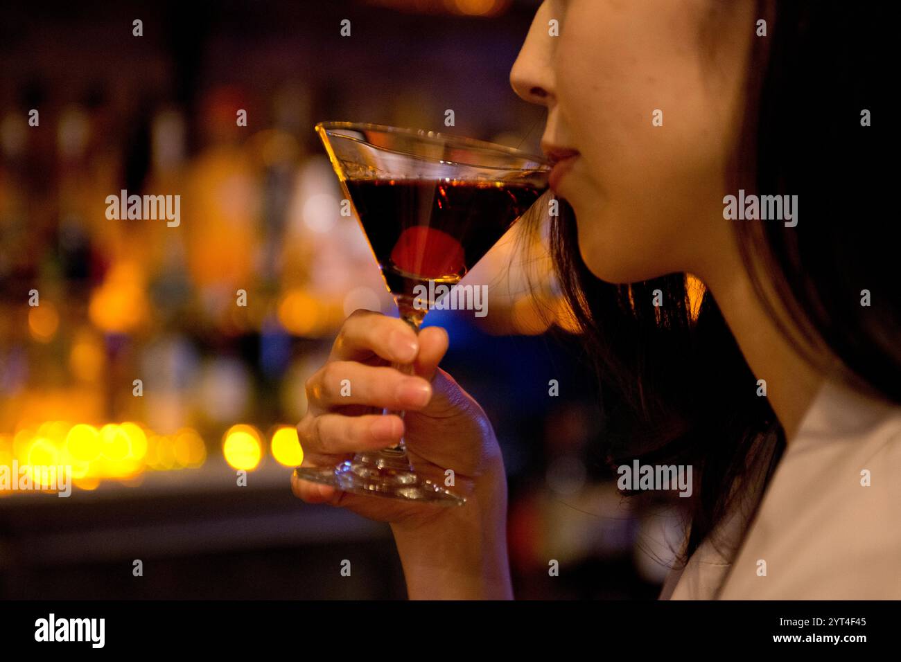Woman drinking alcohol at a bar Stock Photo - Alamy