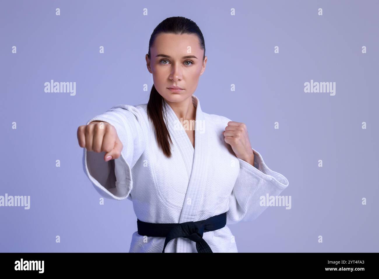 Karate fighter in kimono on light background Stock Photo - Alamy