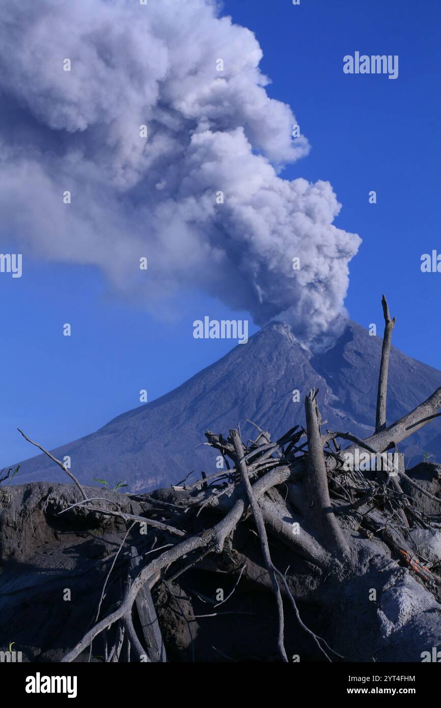 The eruption of Mount Merapi in Yogyakarta, Indonesia. Blue sky ...