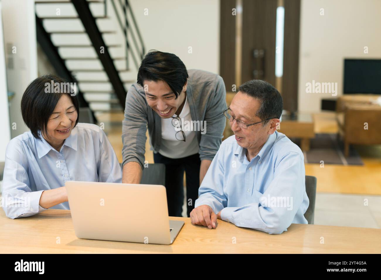 Son teaching his parents to use a computer Stock Photo - Alamy