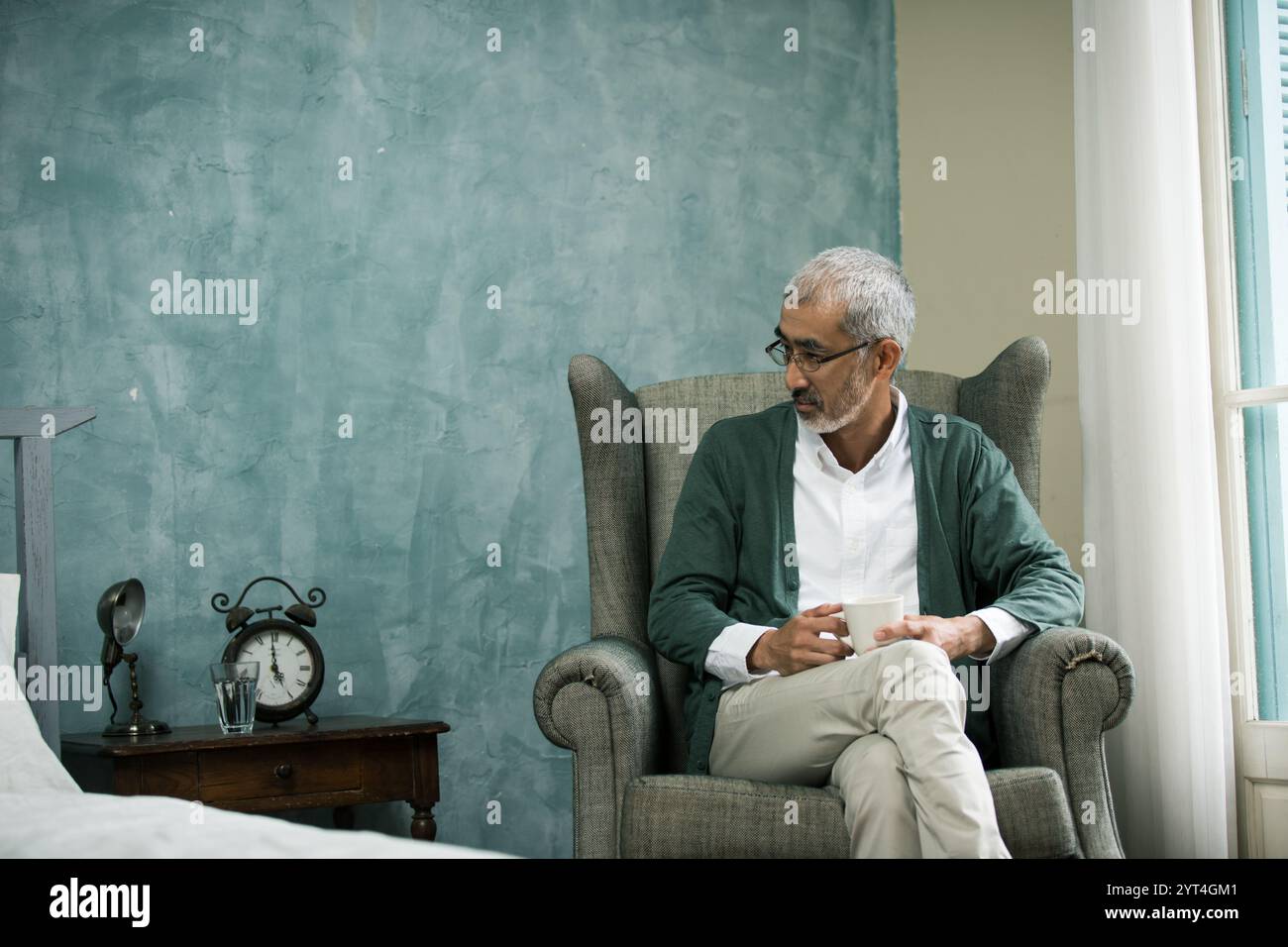 Man sitting on chair Stock Photo - Alamy