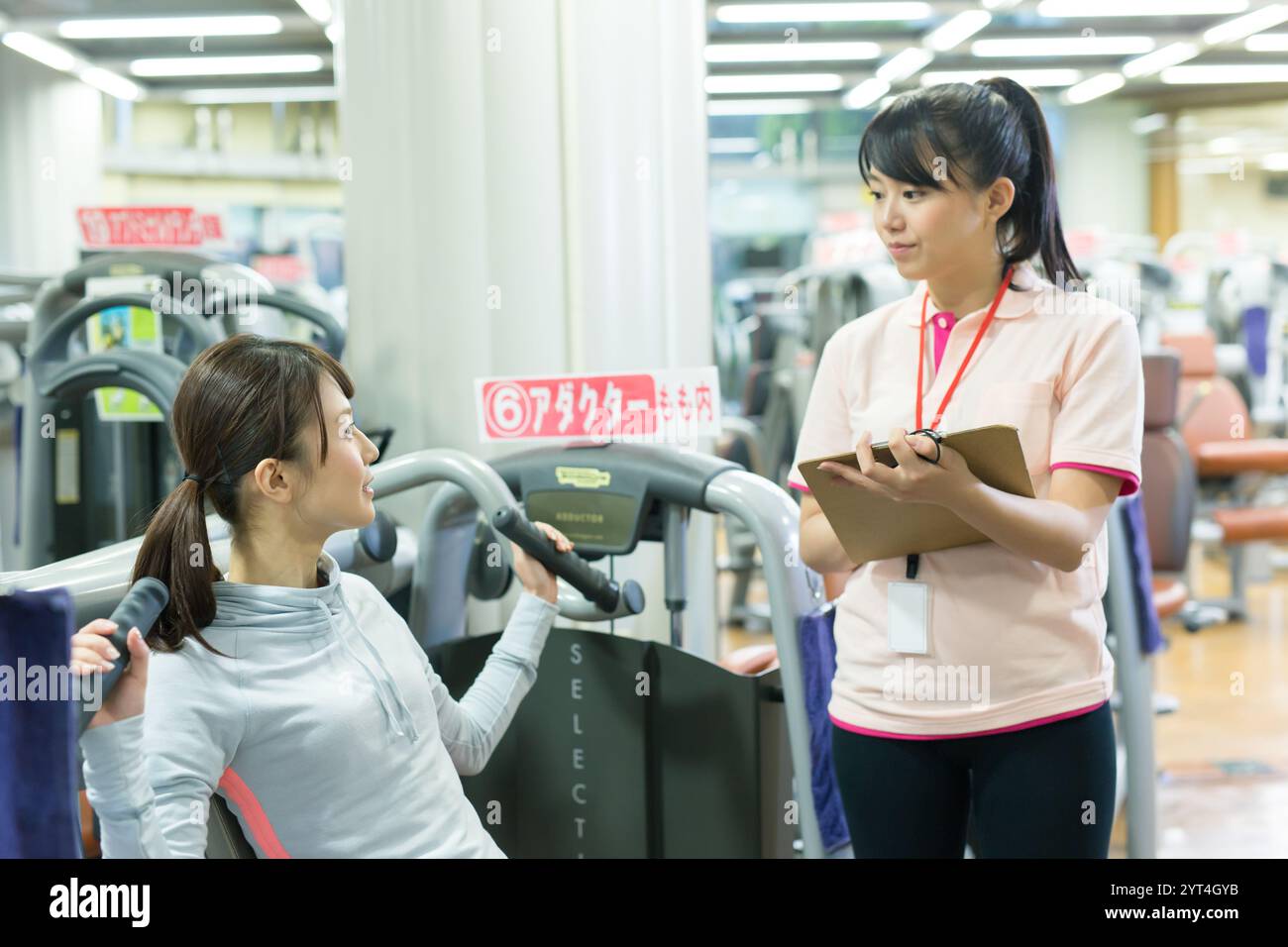 Gym instructor and customer Stock Photo - Alamy