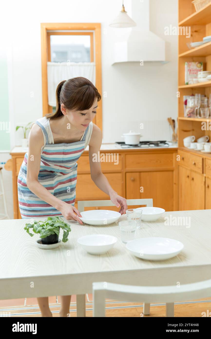 Housewife doing housework in the kitchen Stock Photo - Alamy