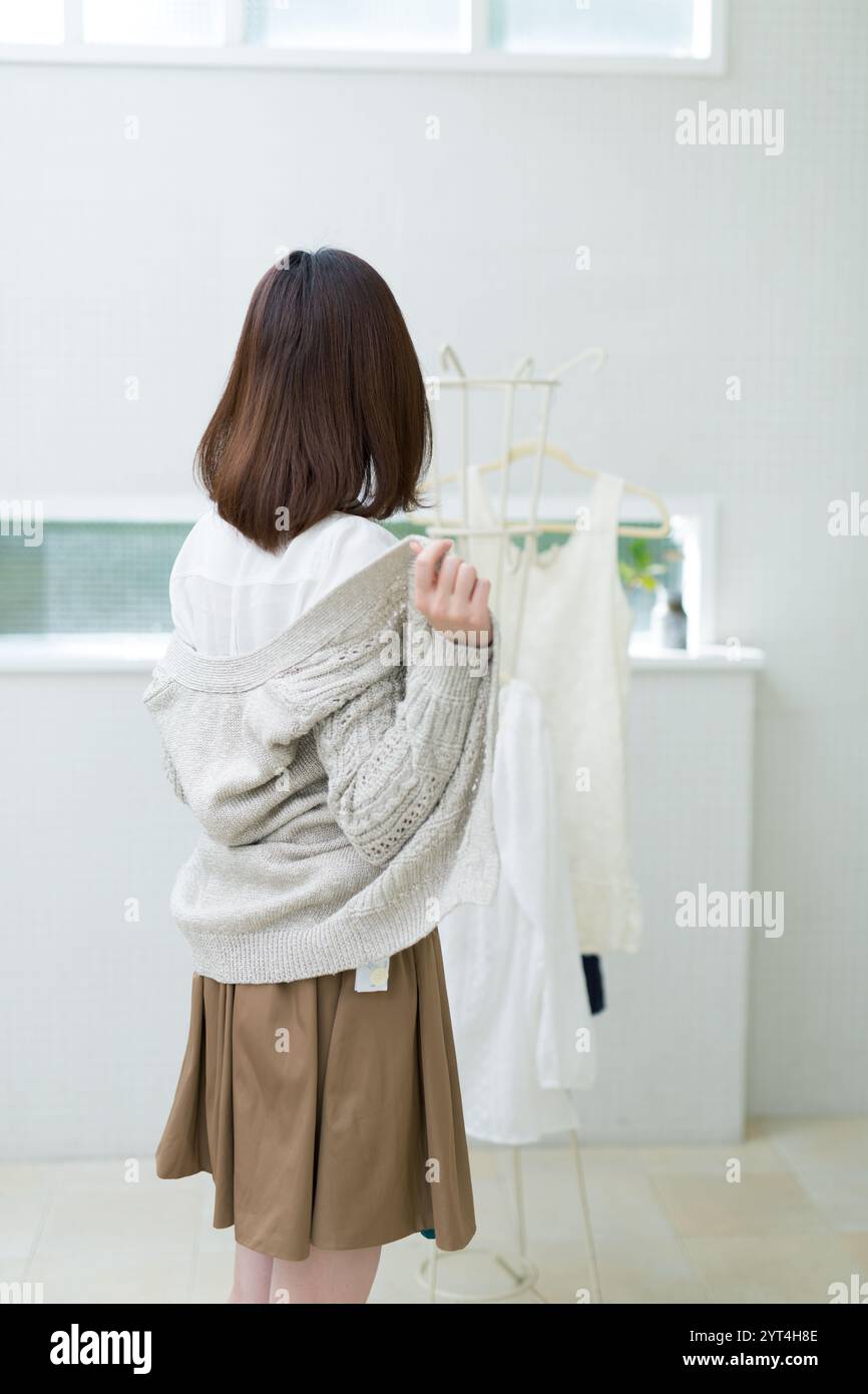 Young woman getting dressed Stock Photo - Alamy