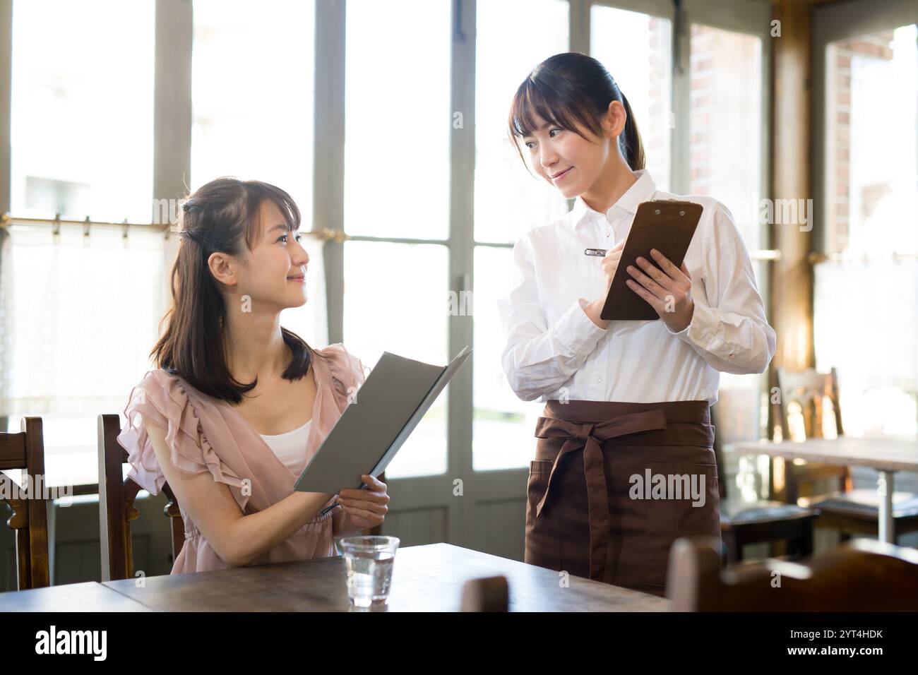Cafe worker and customer Stock Photo - Alamy