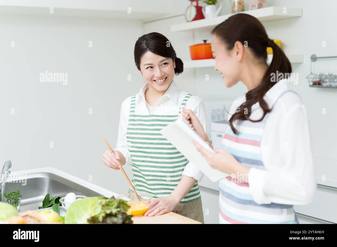 Teacher and student in cooking class Stock Photo - Alamy