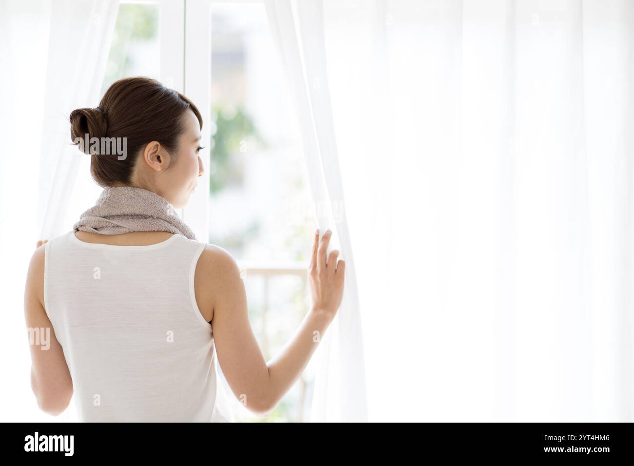 Young woman in front of window Stock Photo - Alamy