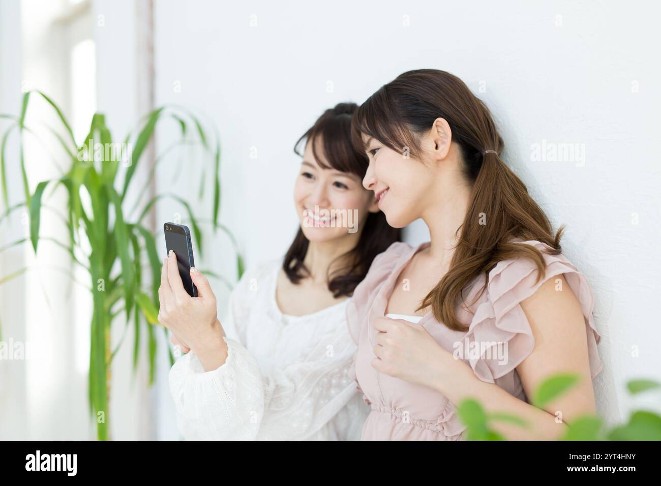 Two women using mobile phones hi-res stock photography and images - Alamy