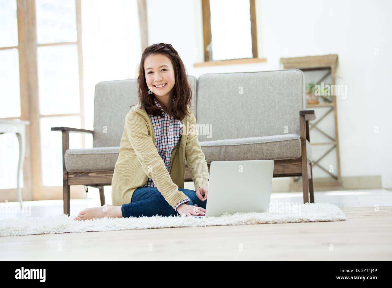 Young women using computer in room Stock Photo - Alamy