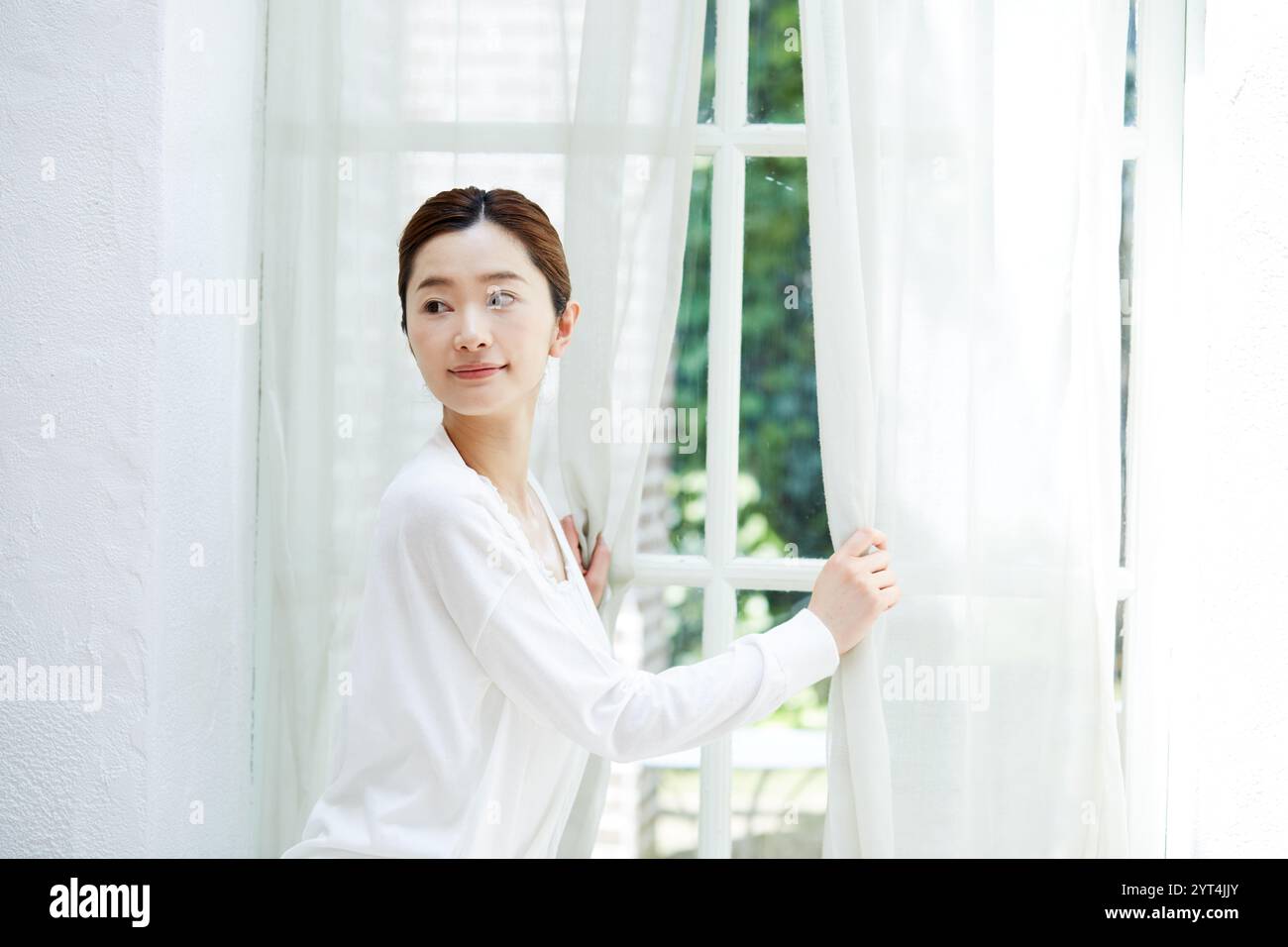 Refreshing woman looking out window Stock Photo - Alamy