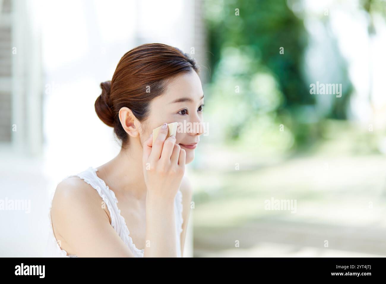 Woman applying natural foundation hi-res stock photography and images ...