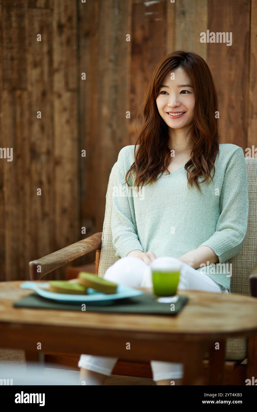 Refreshing woman relaxing at a café Stock Photo - Alamy