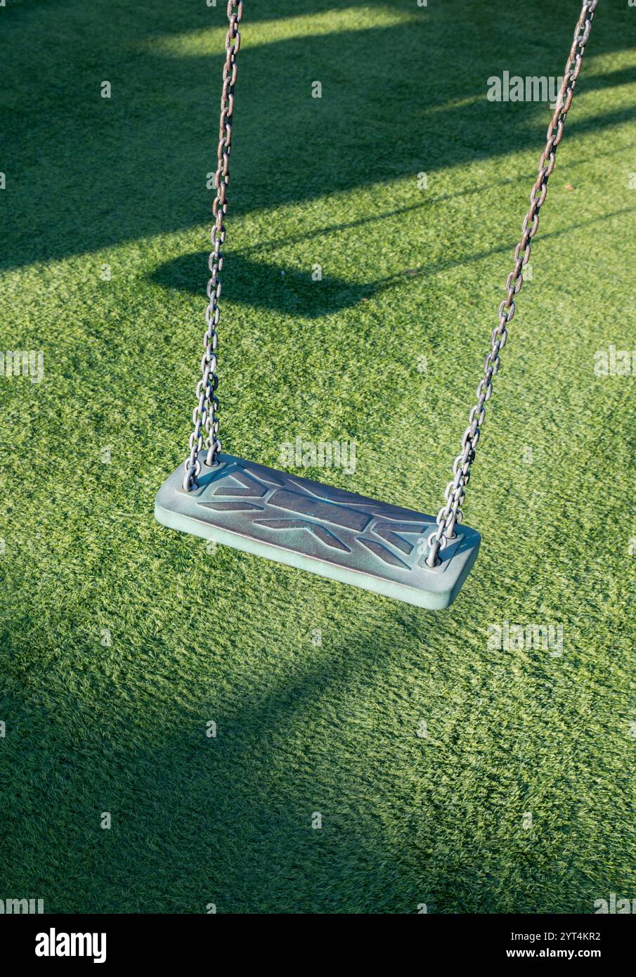 Empty swing on children playground Stock Photo - Alamy