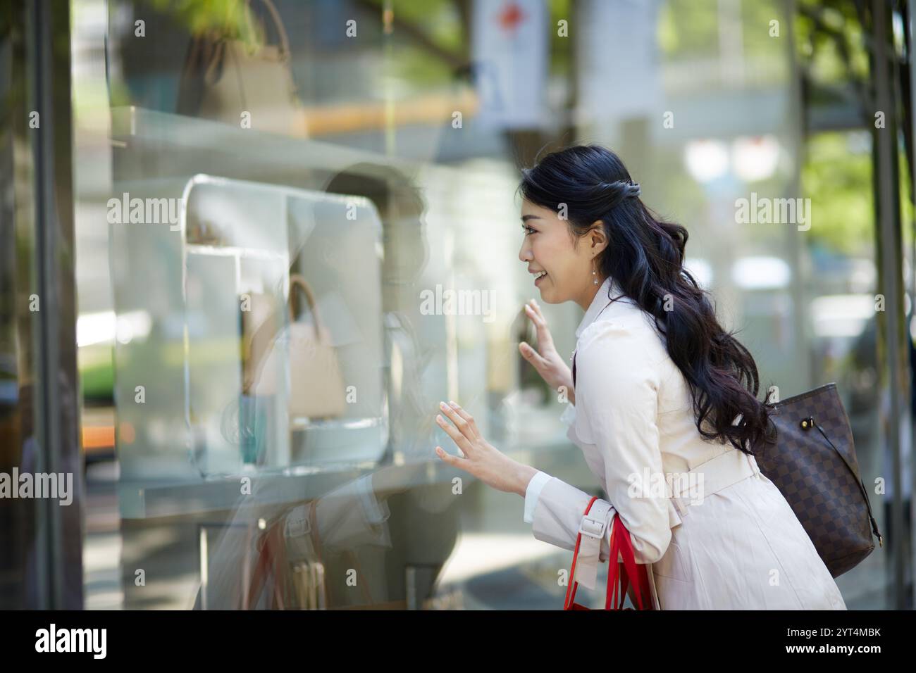 Woman looking through show window Stock Photo - Alamy