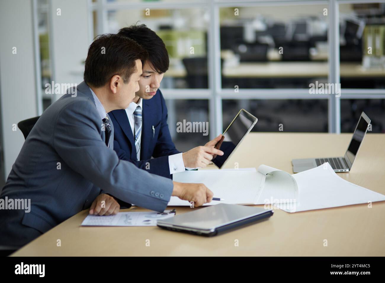 Businessmen during meeting Stock Photo - Alamy