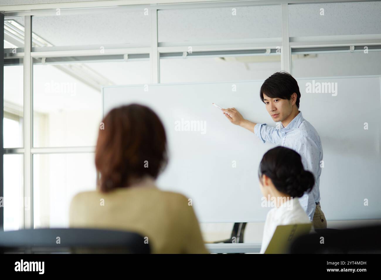 Men explaining on a whiteboard Stock Photo - Alamy