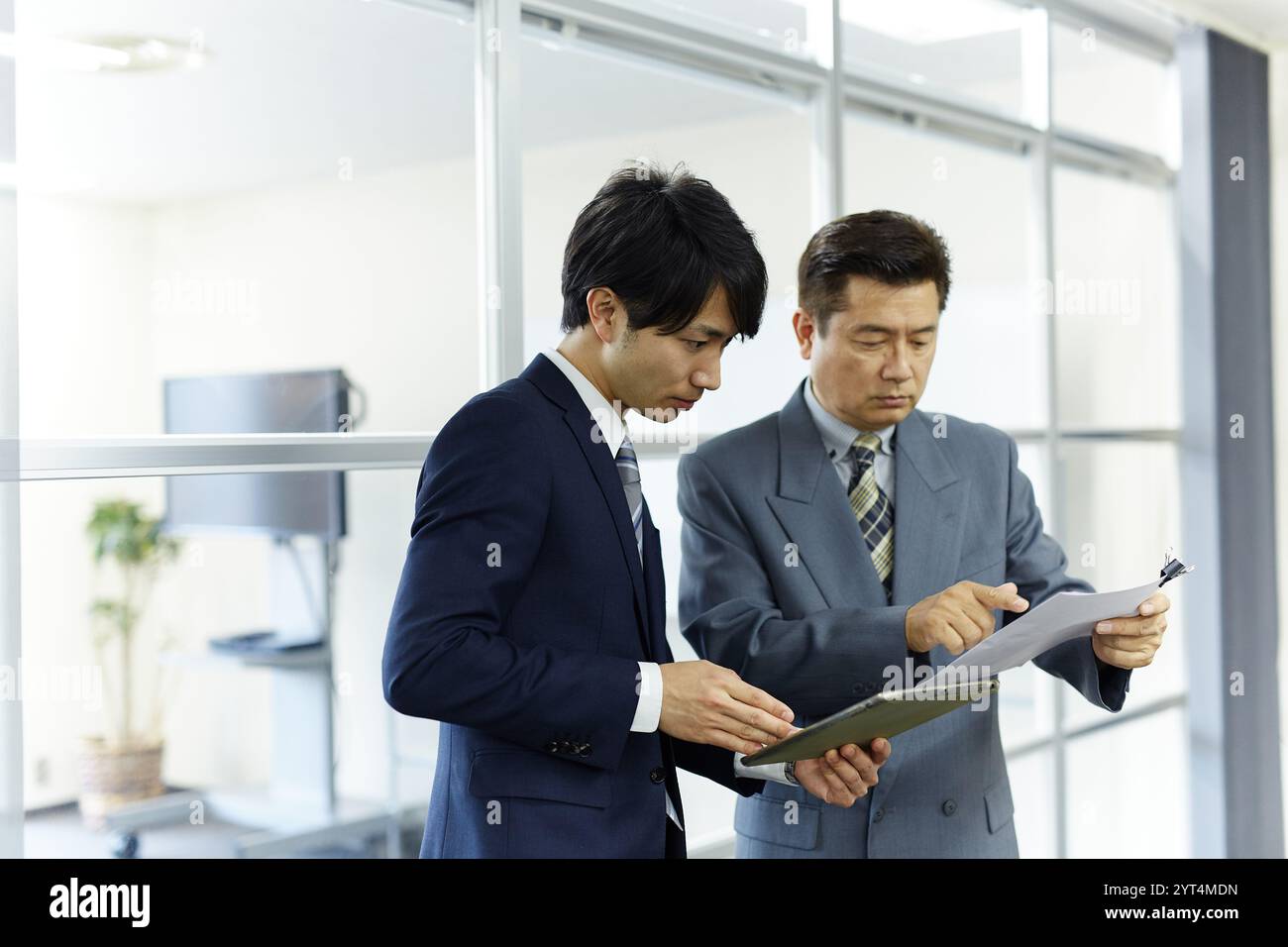 Two business people reviewing documents hi-res stock photography and ...