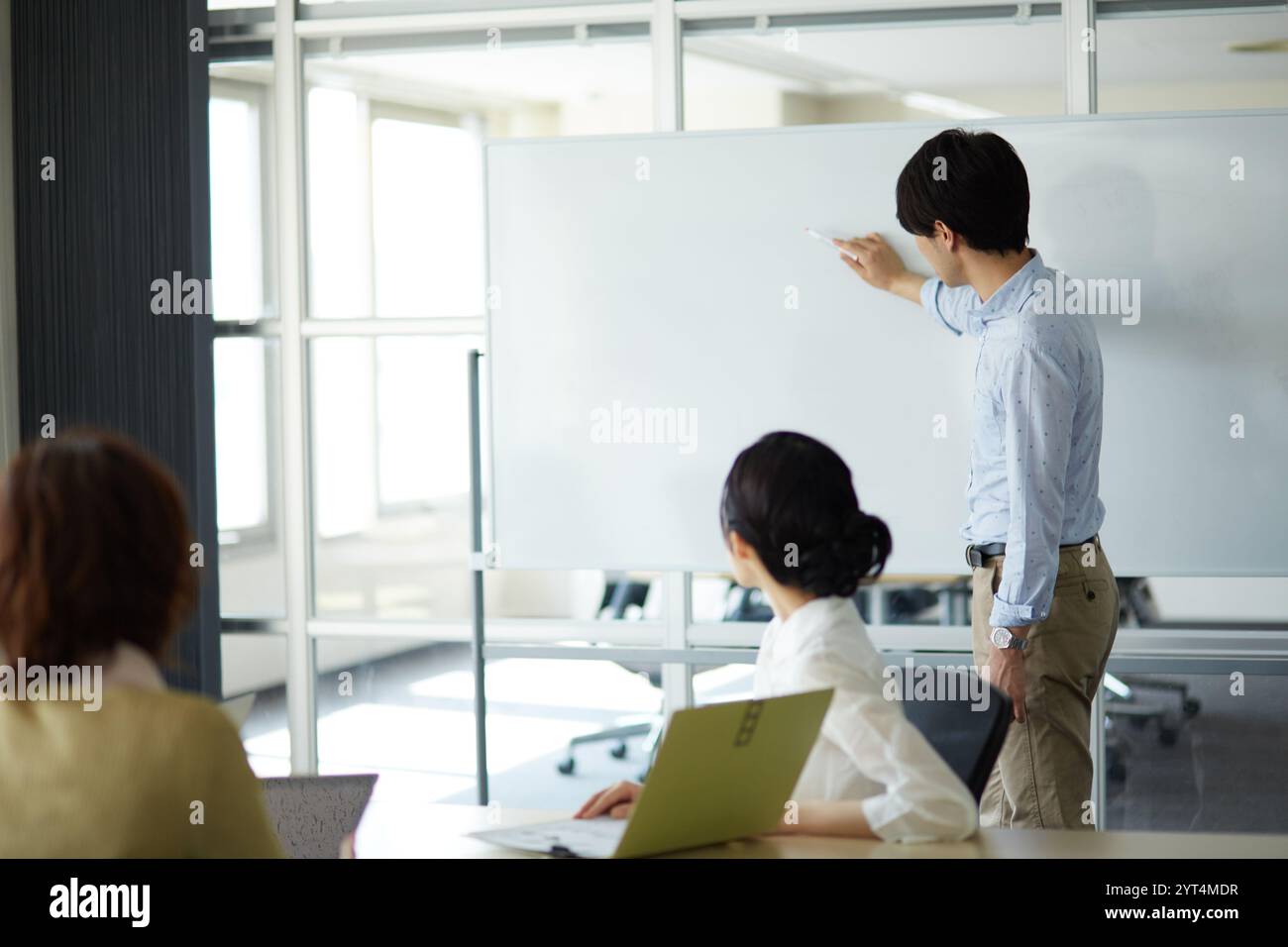 Men explaining on a whiteboard Stock Photo - Alamy