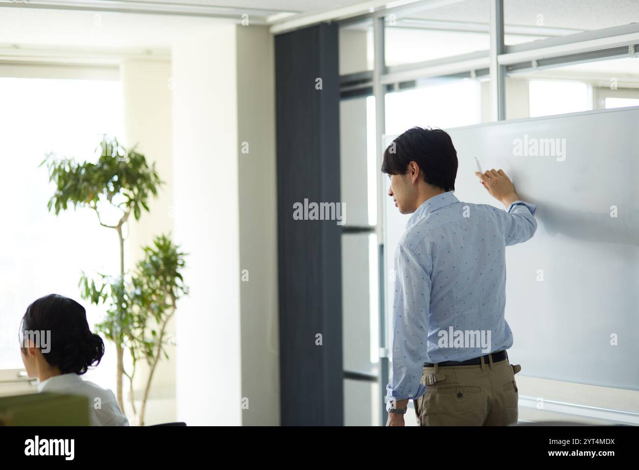 Men explaining on a whiteboard Stock Photo - Alamy