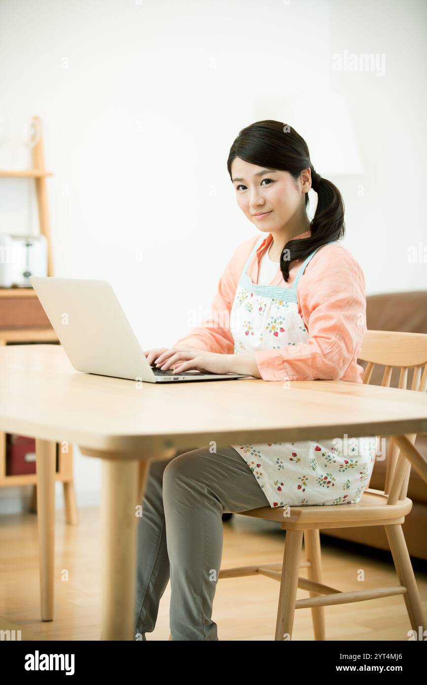 Young housewife using a laptop Stock Photo - Alamy
