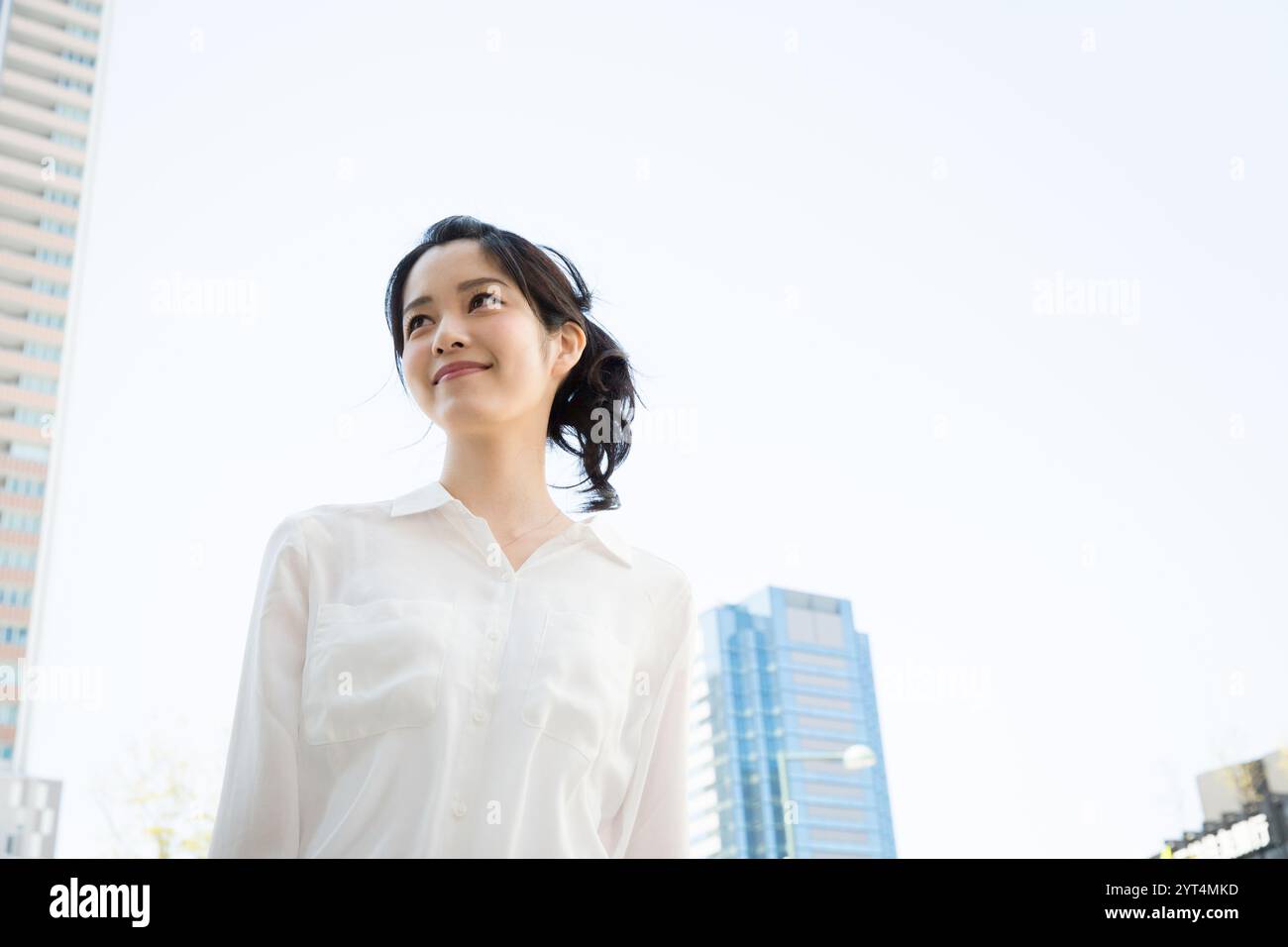 Refreshing woman in front of building Stock Photo - Alamy