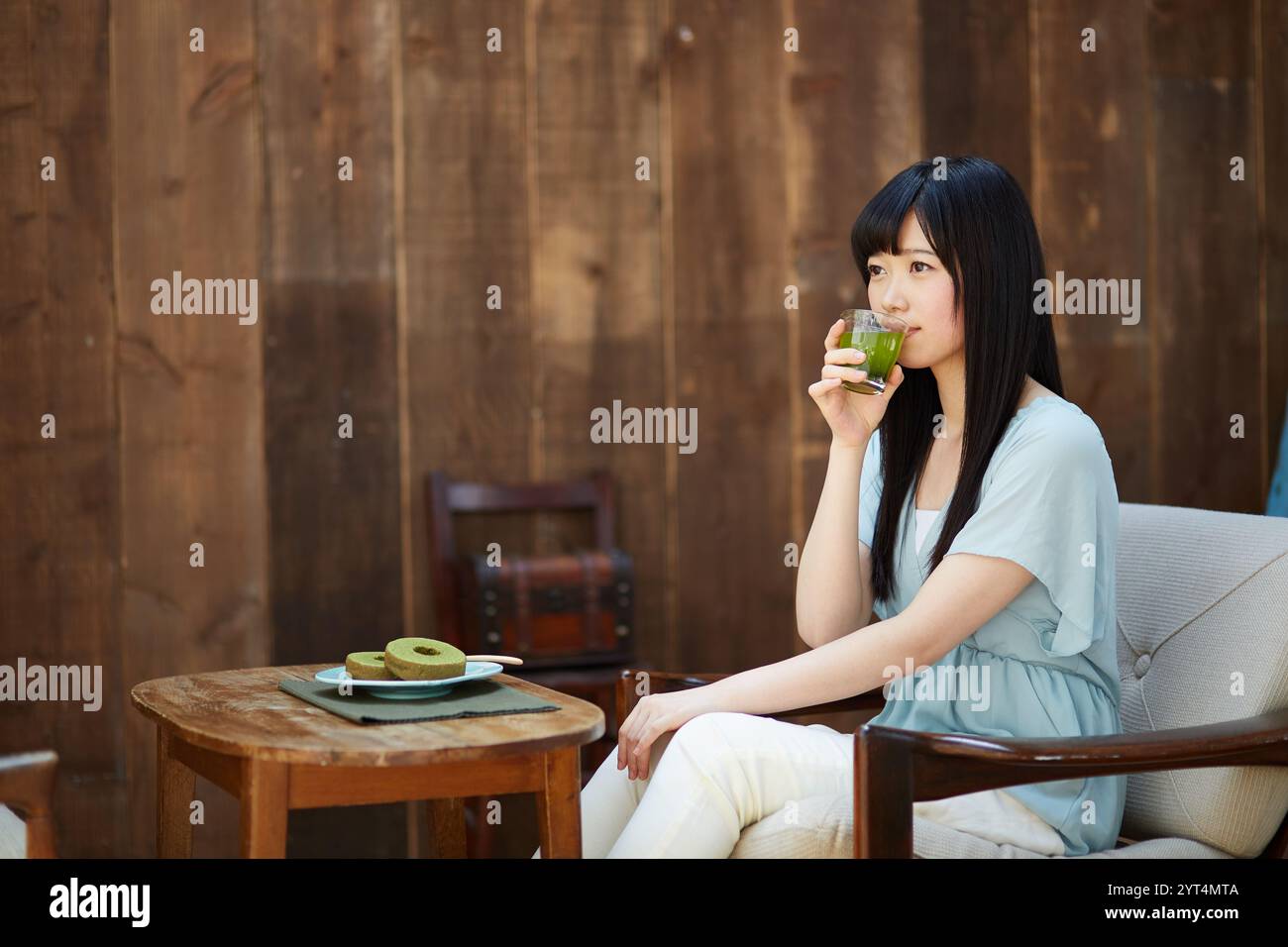 Young woman enjoying tea time Stock Photo - Alamy