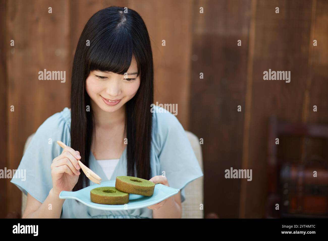 Young woman enjoying tea time Stock Photo - Alamy