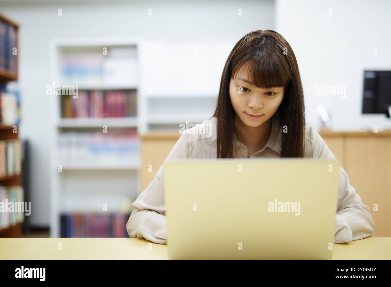 Female university students using computers in the library Stock Photo ...