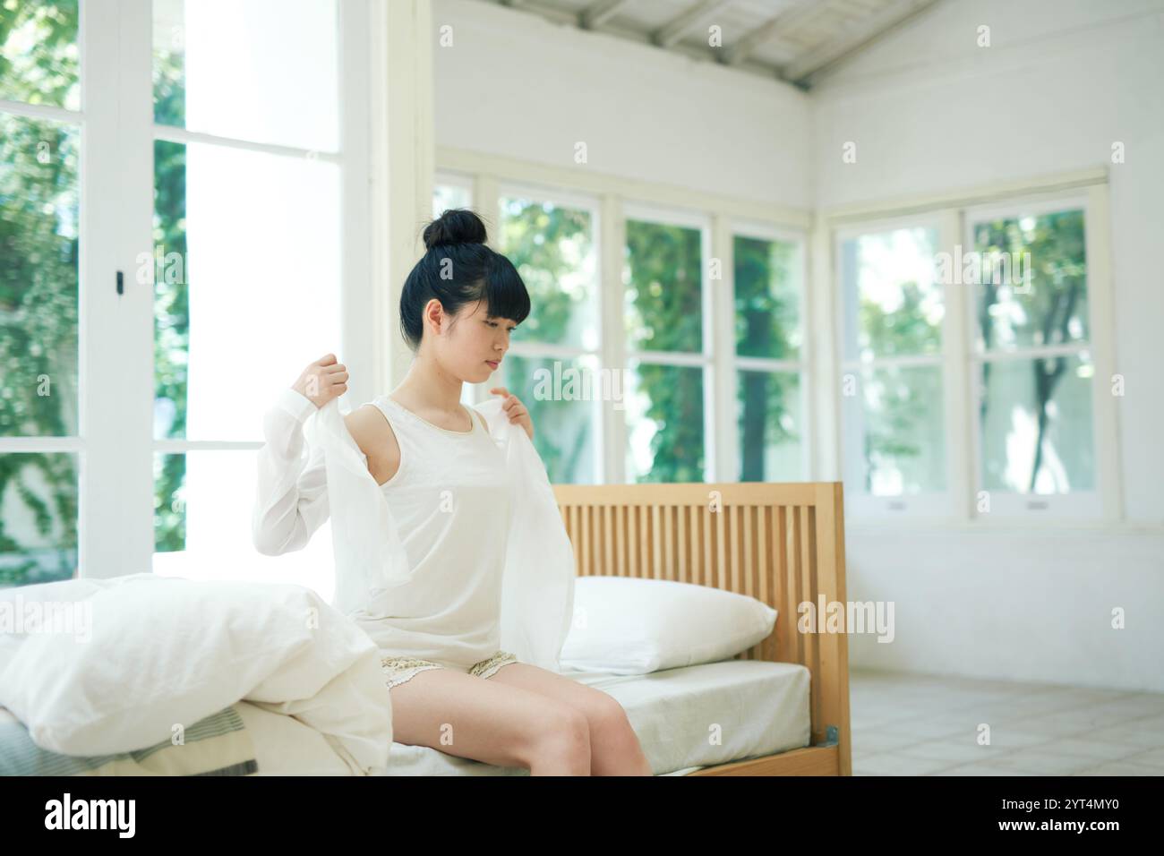 Woman changing clothes in the morning Stock Photo - Alamy