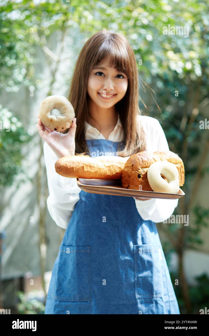 Woman in work apron hi-res stock photography and images - Alamy