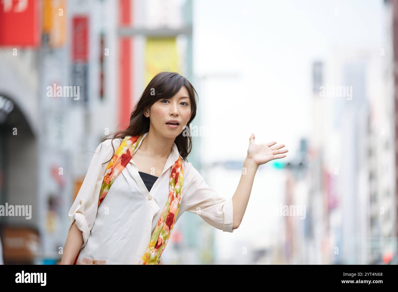 Fresh woman calling a taxi Stock Photo - Alamy