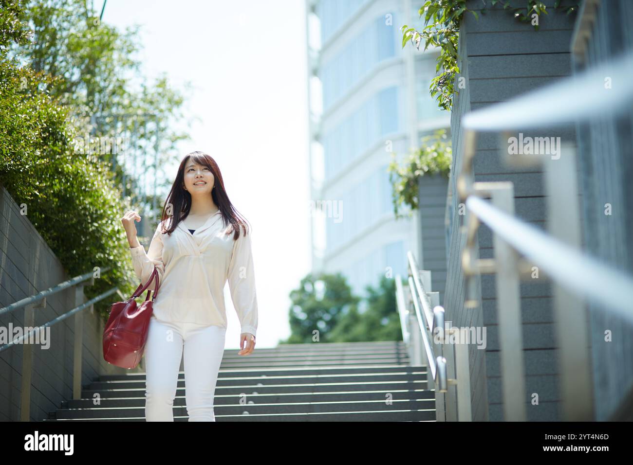 Woman descending stairs hi-res stock photography and images - Alamy