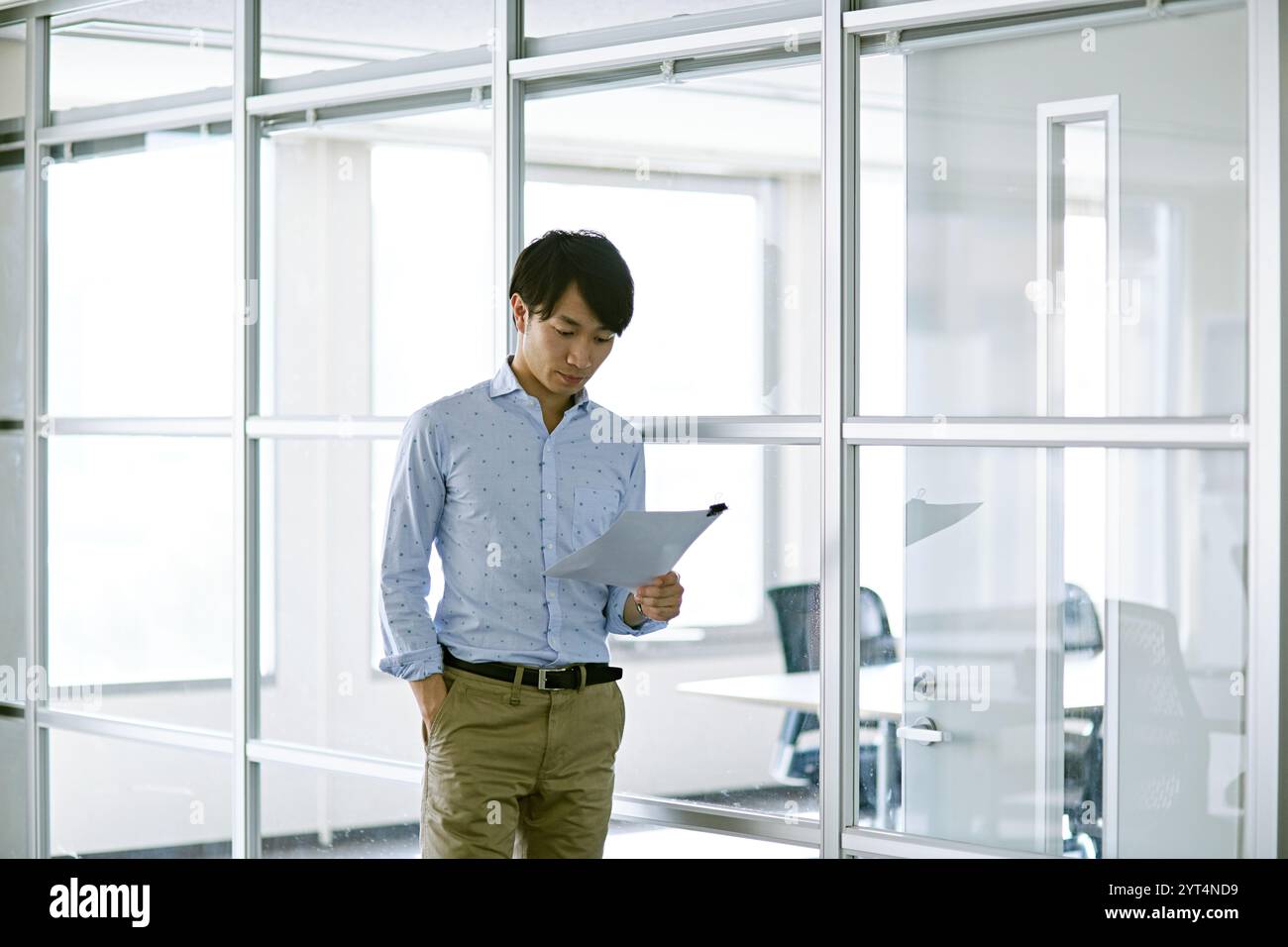 Man looking through documents Stock Photo - Alamy