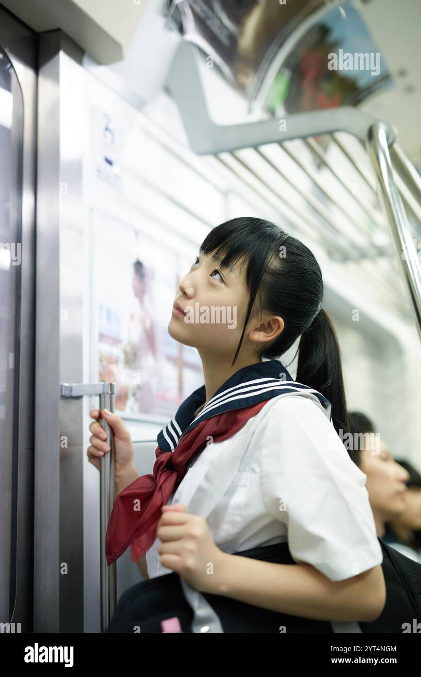 High school girls commuting by train Stock Photo - Alamy
