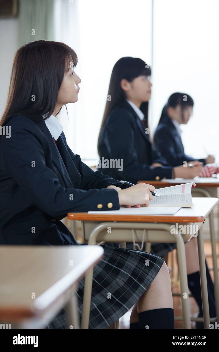 Female high school students in class Stock Photo - Alamy
