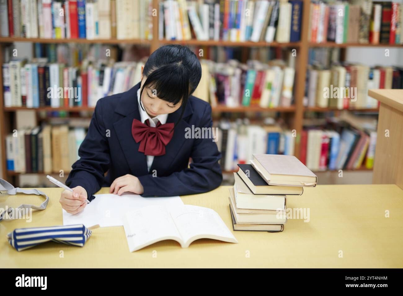 Female high school student studying in the library Stock Photo - Alamy