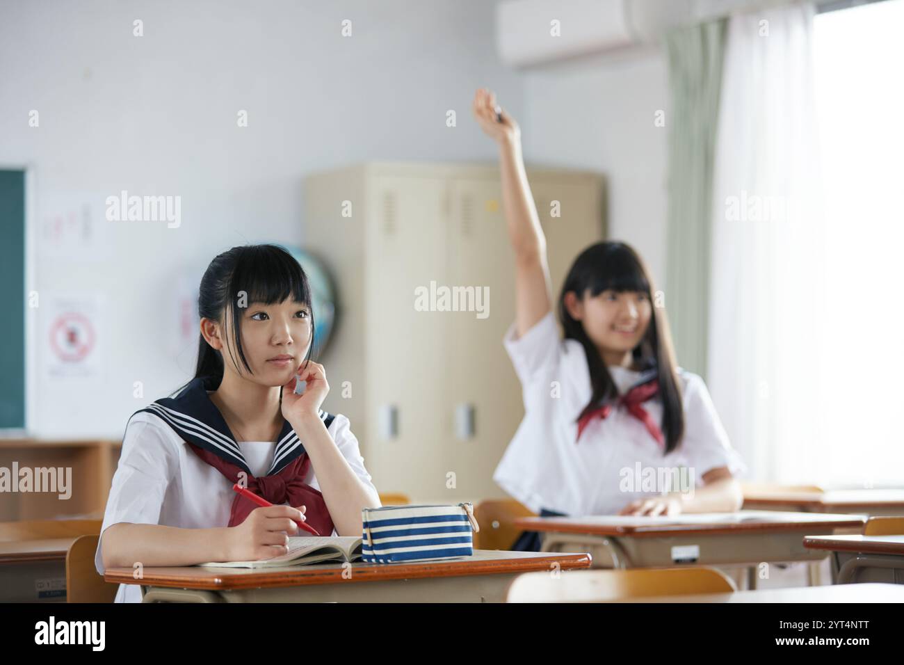 Female high school students in class Stock Photo - Alamy