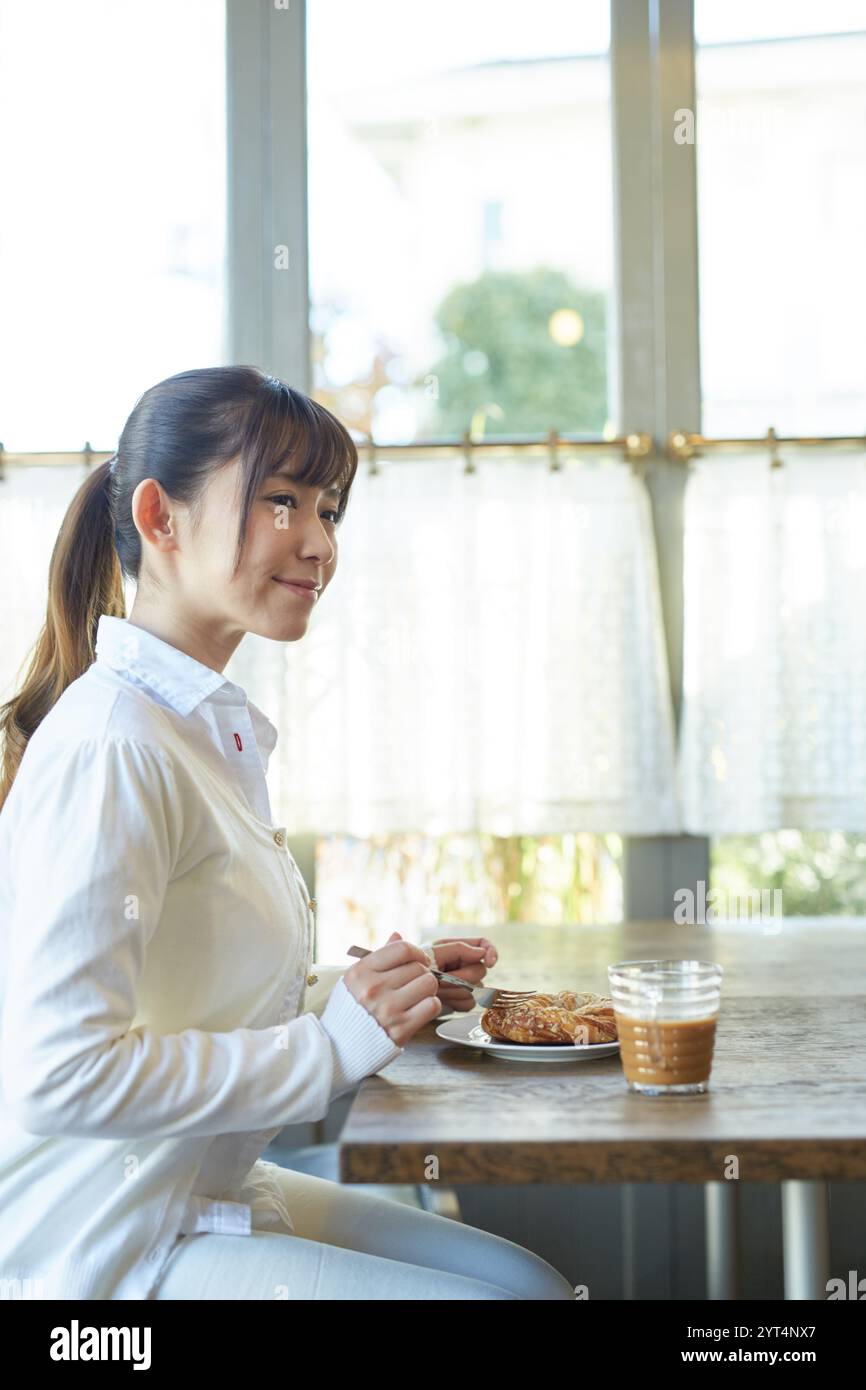 Woman eating sweets hi-res stock photography and images - Alamy
