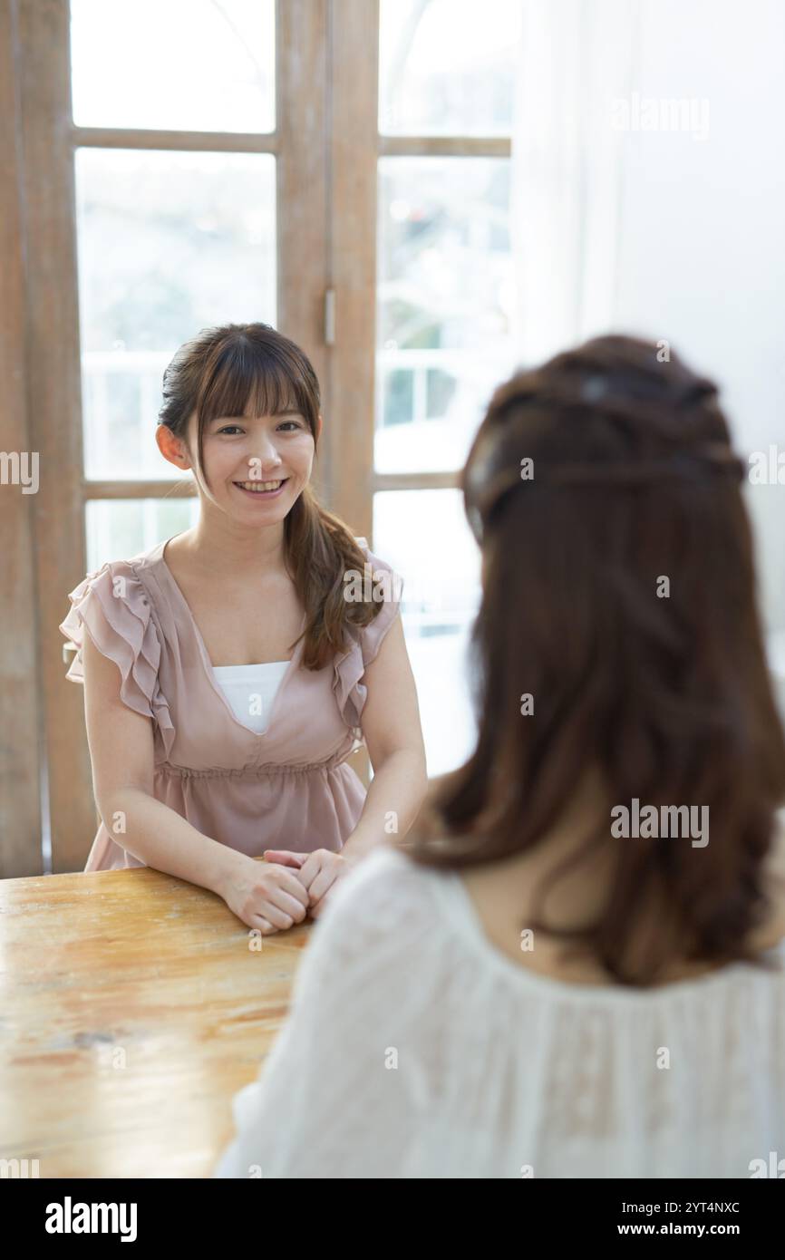 Two women in conversation Stock Photo - Alamy