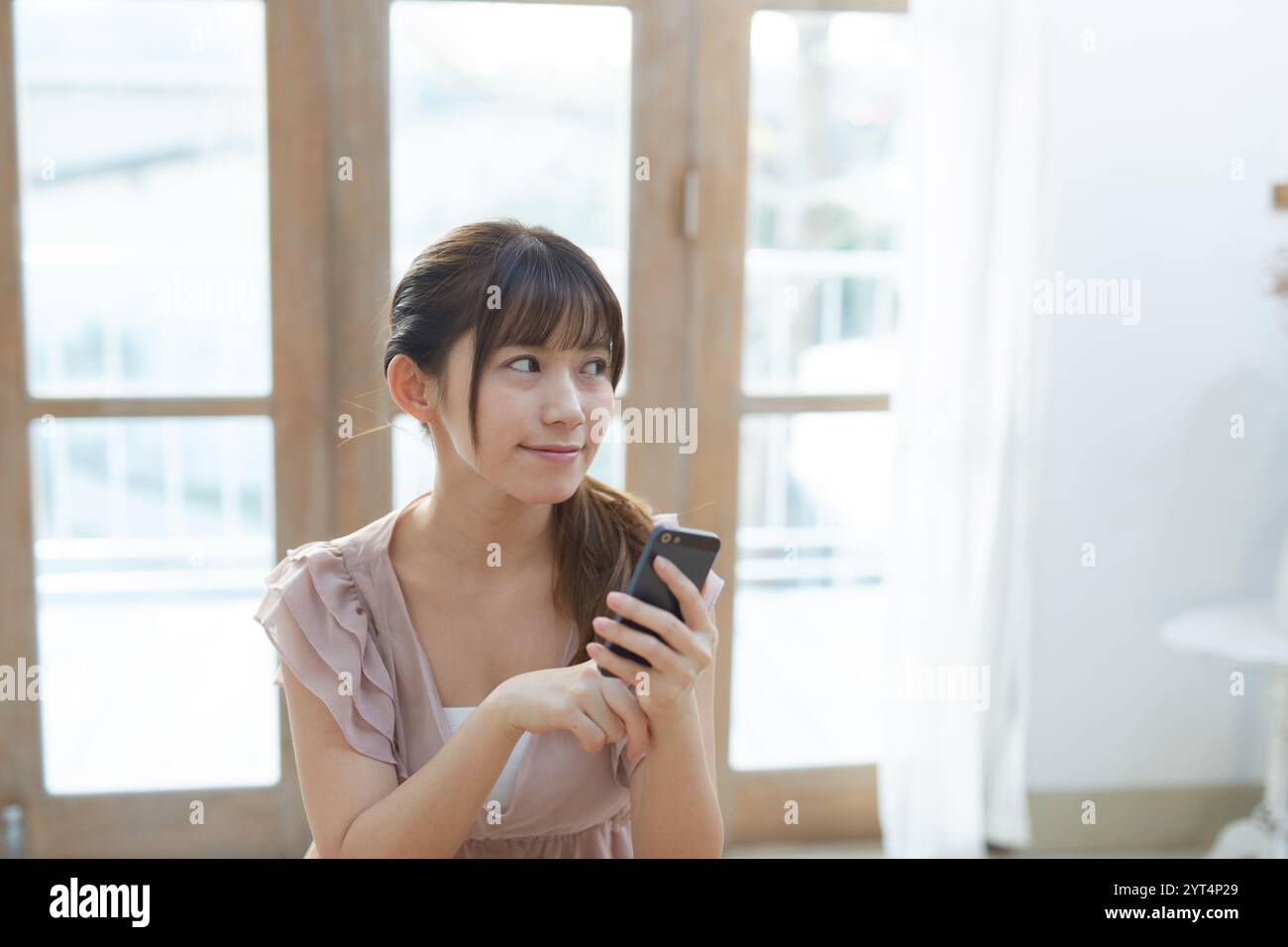 Young women using a smartphone Stock Photo - Alamy