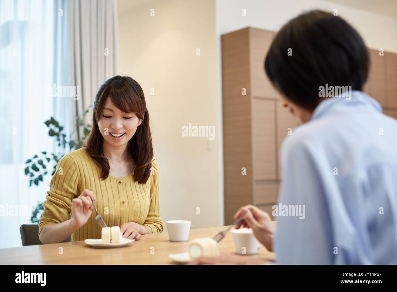 Parent and child eating sweets Stock Photo - Alamy