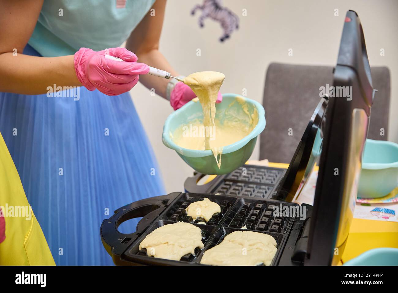 The process of making homemade Belgian (Viennese) waffles. A woman's ...