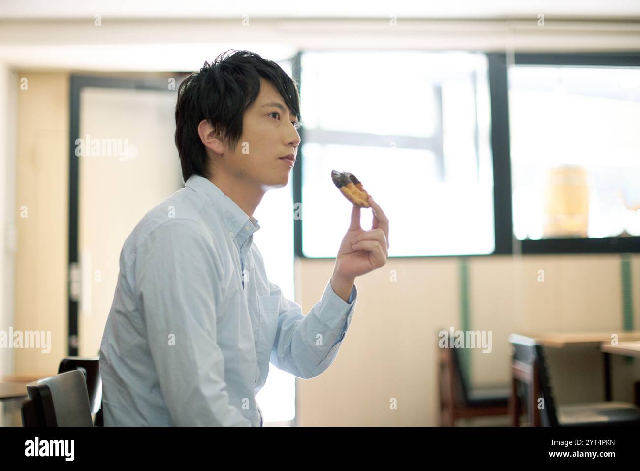 Man eating doughnut café hi-res stock photography and images - Alamy