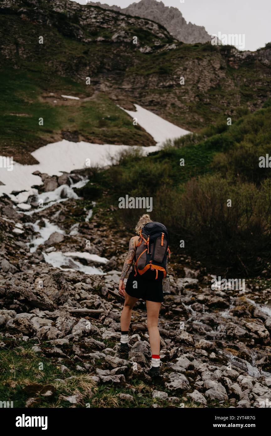 Female Hiker Exploring Mountain Terrain with a Backpack Stock Photo - Alamy